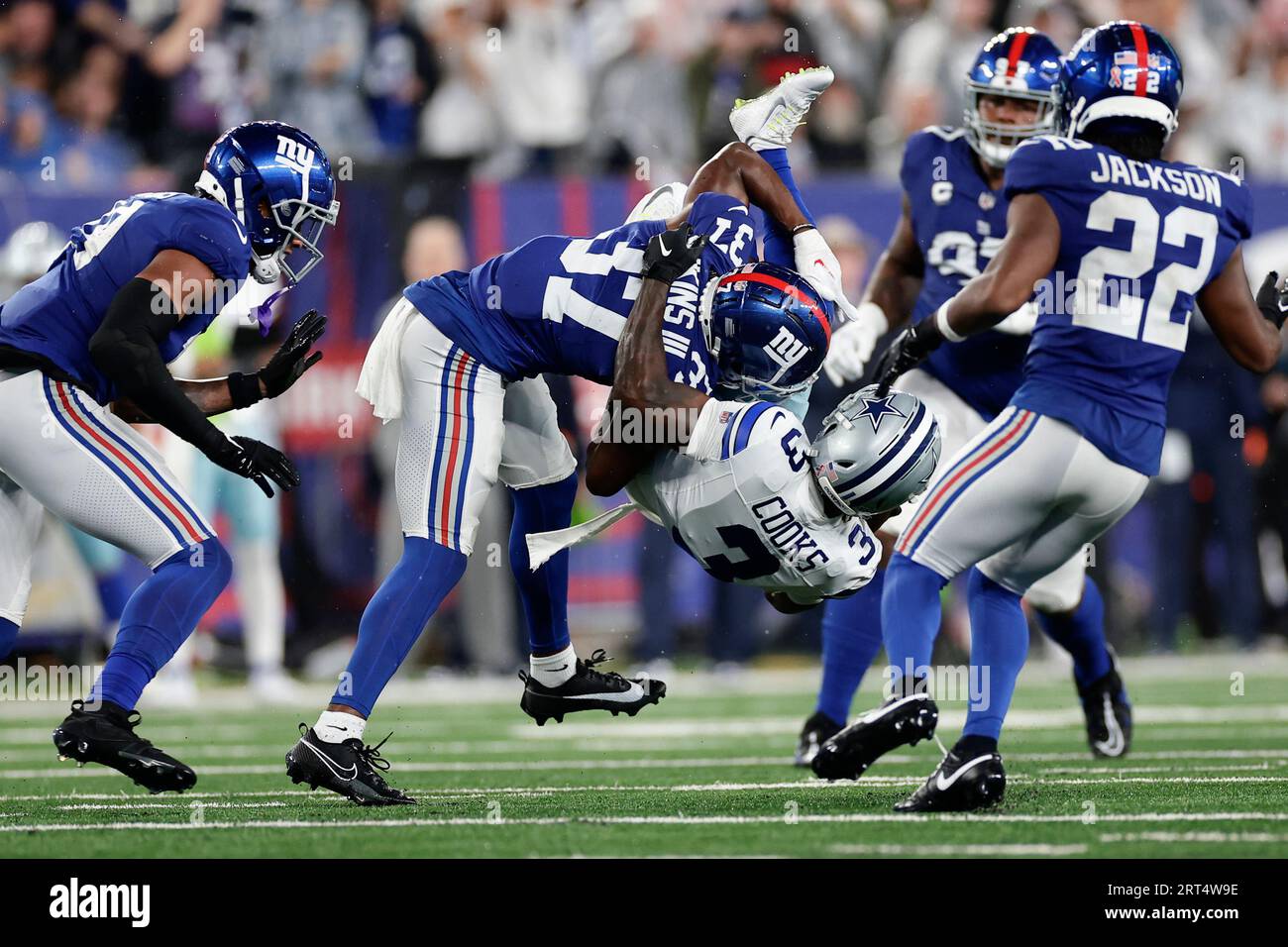 New York Giants' Tre Hawkins III (37), second from left, left, tackles ...
