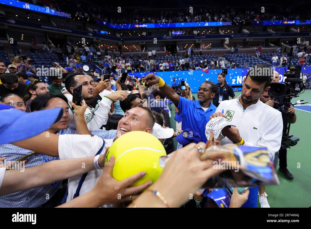 Novak Djokovic signs autographs for fans after winning a men's singles ...