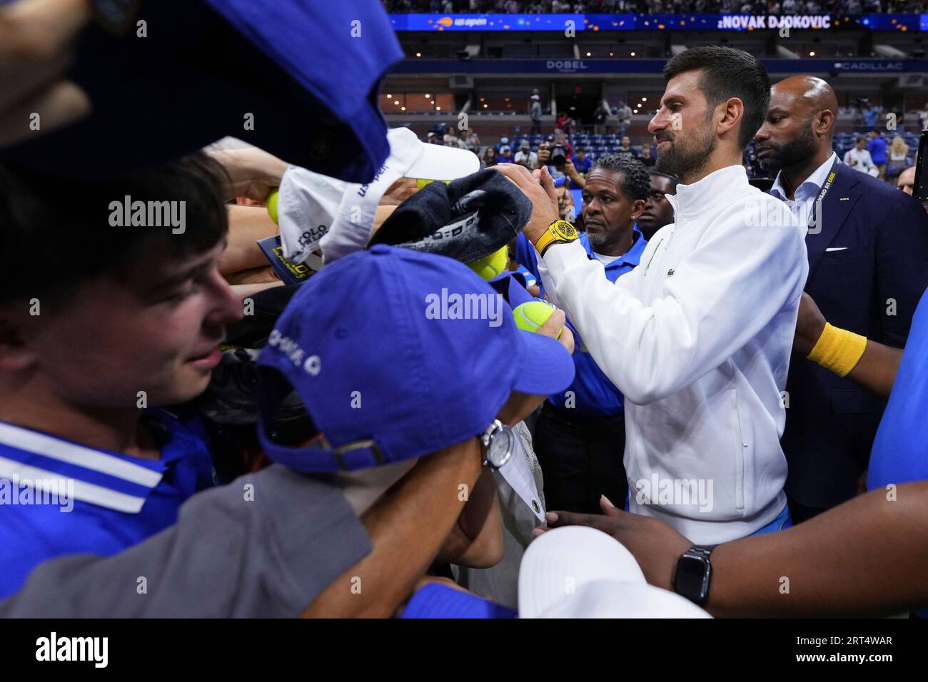 Novak Djokovic signs autographs for fans after winning a men's singles ...