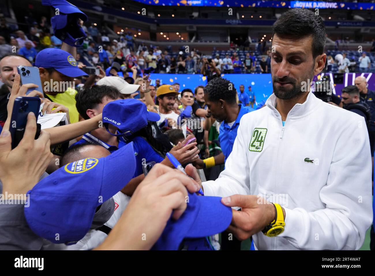 Novak Djokovic signs autographs for fans after winning a men's singles ...