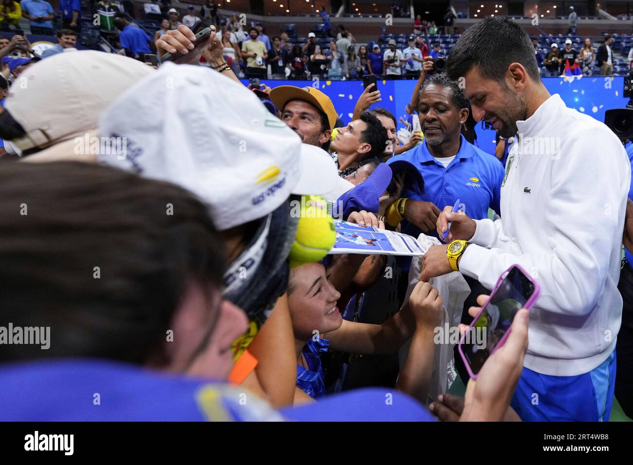 Novak Djokovic signs autographs for fans after winning a men's singles ...