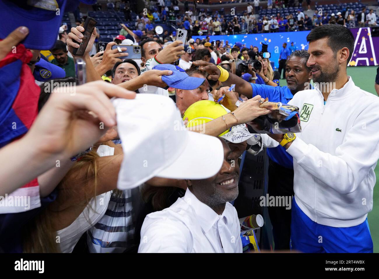 Novak Djokovic signs autographs for fans after winning a men's singles ...