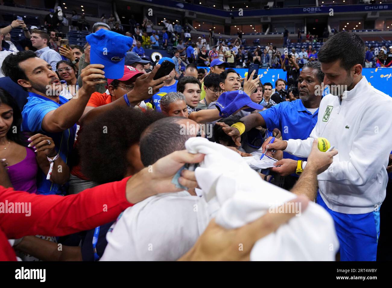 Novak Djokovic signs autographs for fans after winning a men's singles ...