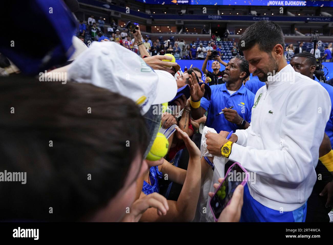 Novak Djokovic signs autographs for fans after winning a men's singles ...