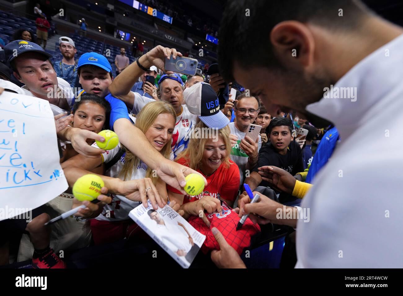 Novak Djokovic signs autographs for fans after winning a men's singles ...