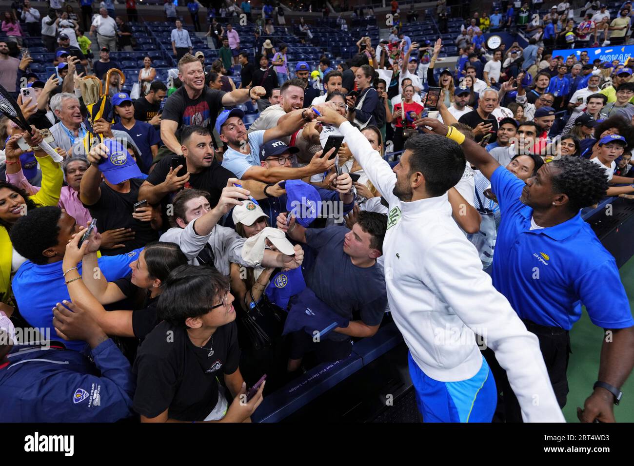Novak Djokovic signs autographs for fans after winning a men's singles ...