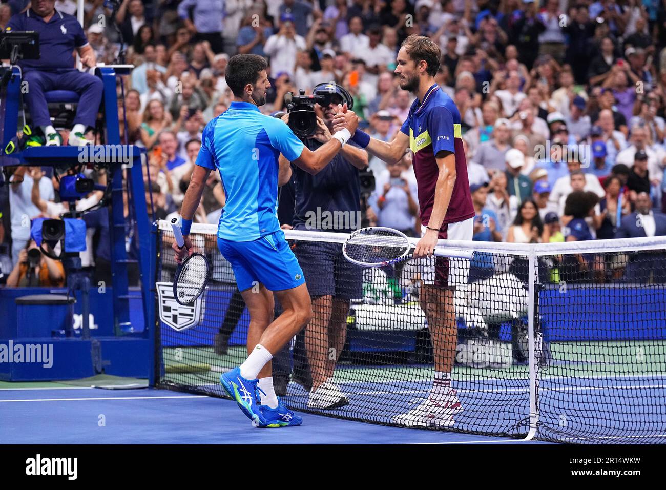 Novak Djokovic shakes hands with Daniil Medvedev after a men's singles championship match at the ...