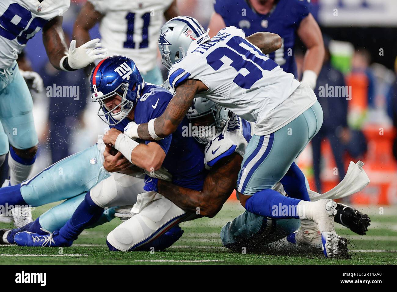 New York Giants quarterback Daniel Jones, left, is sacked during the ...