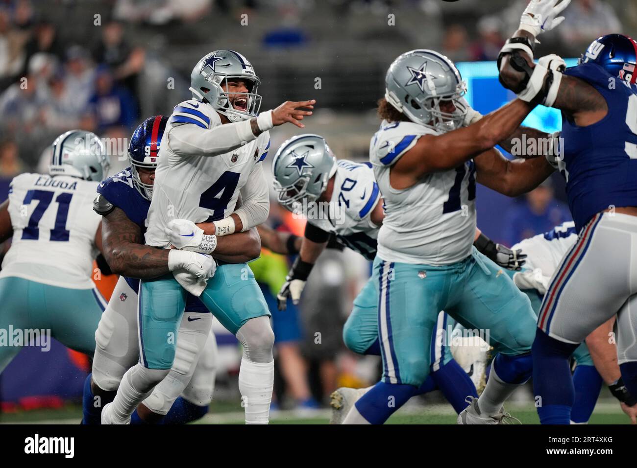 Dallas Cowboys quarterback Dak Prescott (4), center, left, reacts as he ...