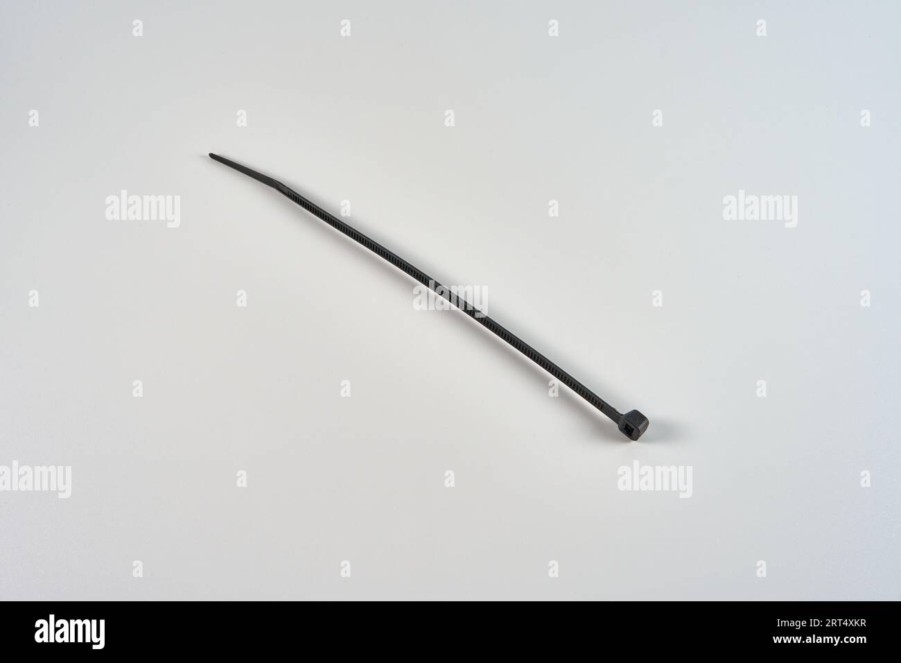 One zip tie on a white background Stock Photo - Alamy