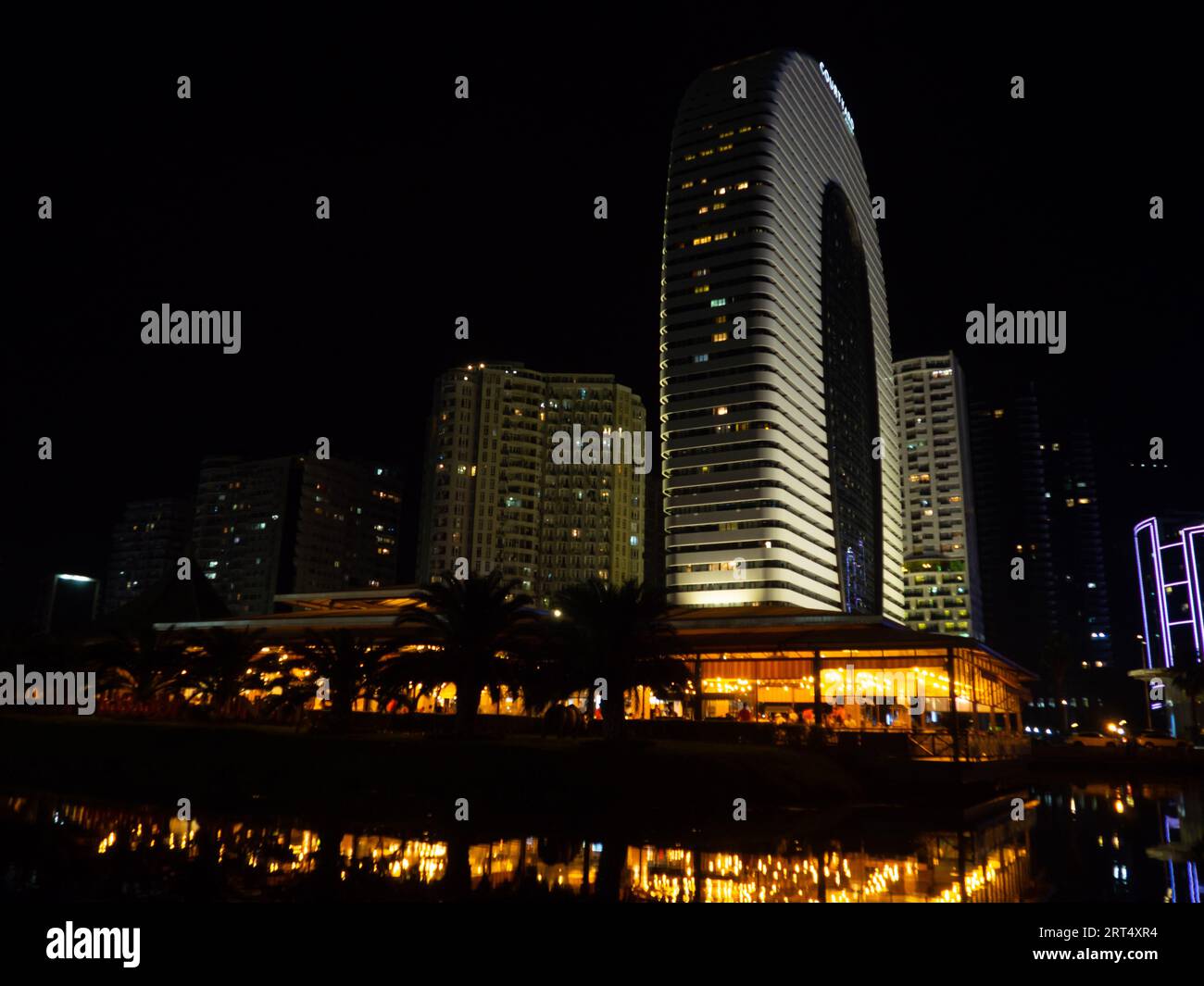 Night city in lights. High-rise buildings at the resort. Just like in ...