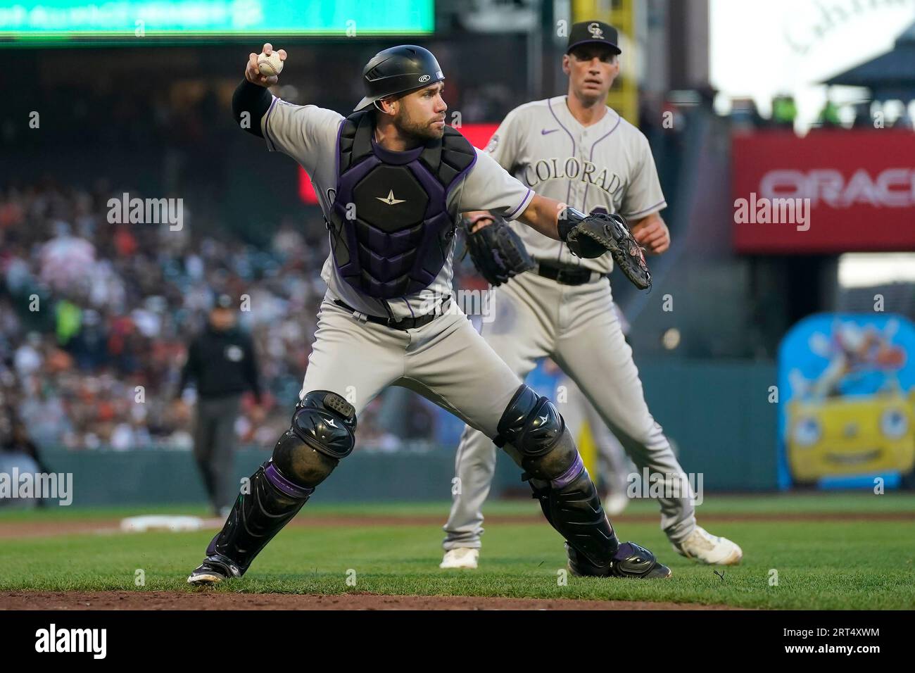 Colorado Rockies catcher Austin Wynns, left, throws out San Francisco ...