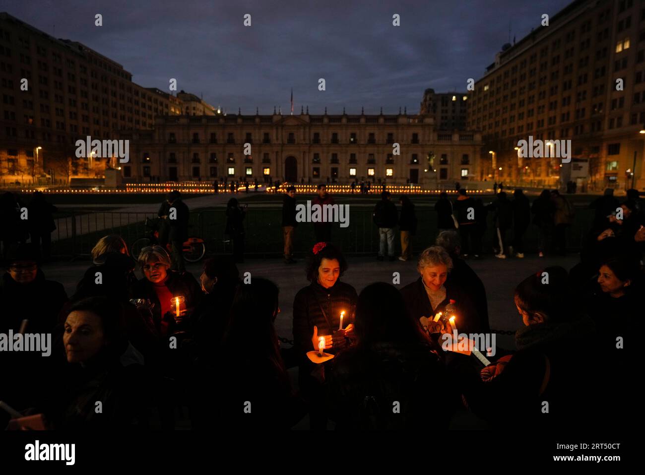 Women's rights activists hold candles during a vigil for the victims of ...