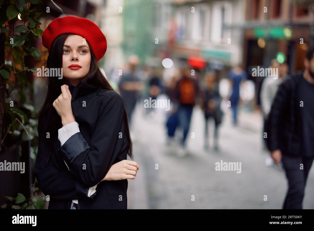 Woman walking down an old city street in a crowd, sociophobia, fear of ...