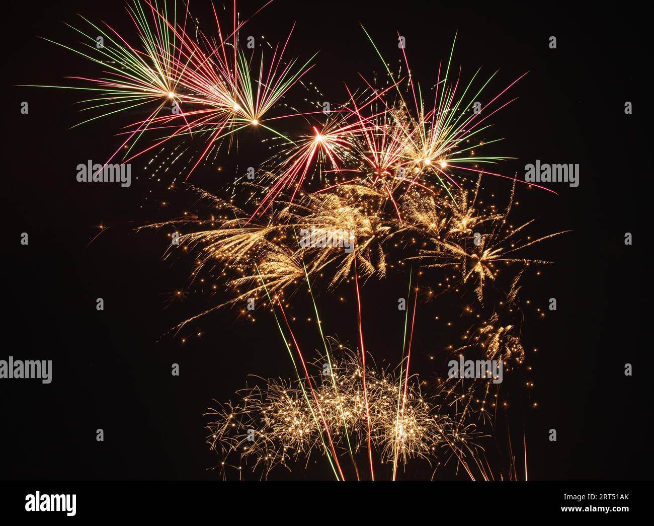 celebrating multiple colorful fireworks at night Stock Photo - Alamy