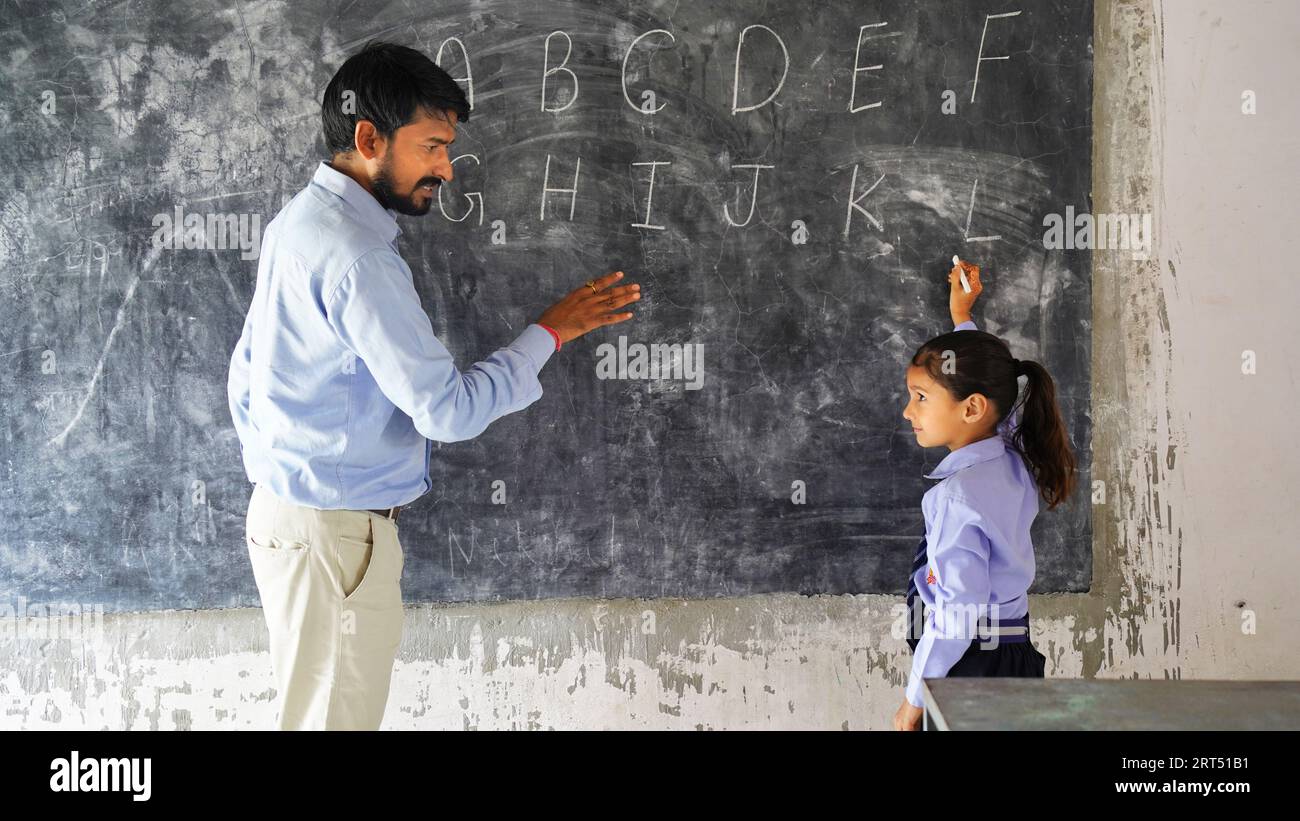 Indian teacher teaching to rural school student in classroom, Typical ...