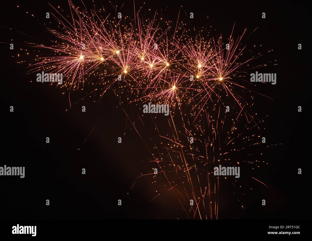 celebrating multiple bright pink fireworks at night Stock Photo - Alamy