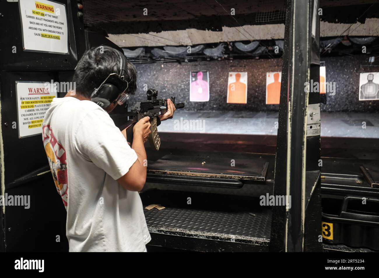A man holds an assault rifle during the gun training. Even though there ...