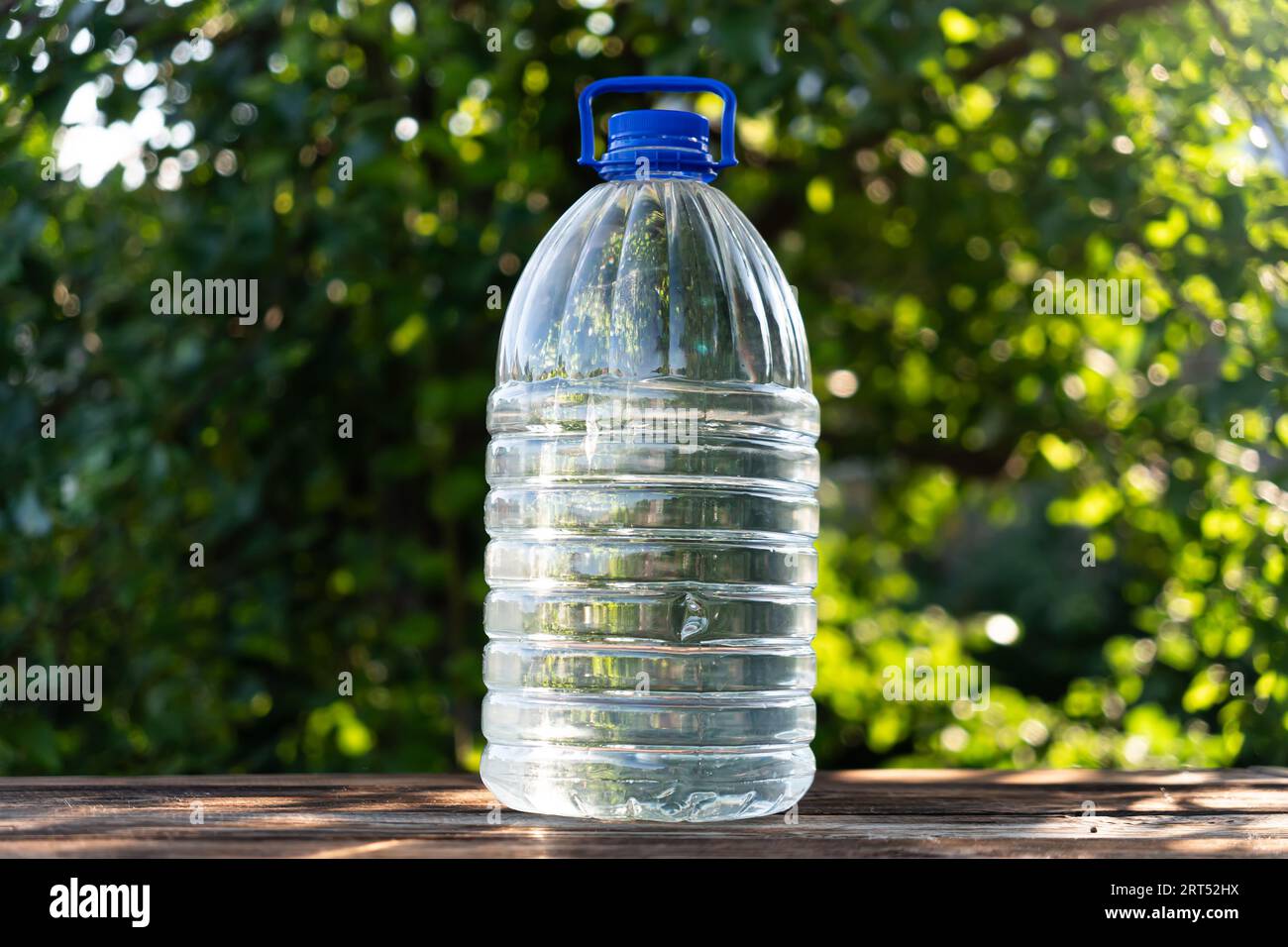 Bottle water made to plastic and green background. refreshing image and ...