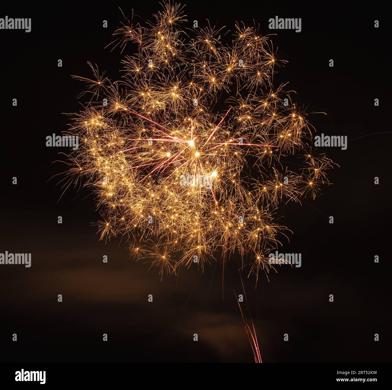 celebrating multiple bright red and yellow fireworks at night Stock ...