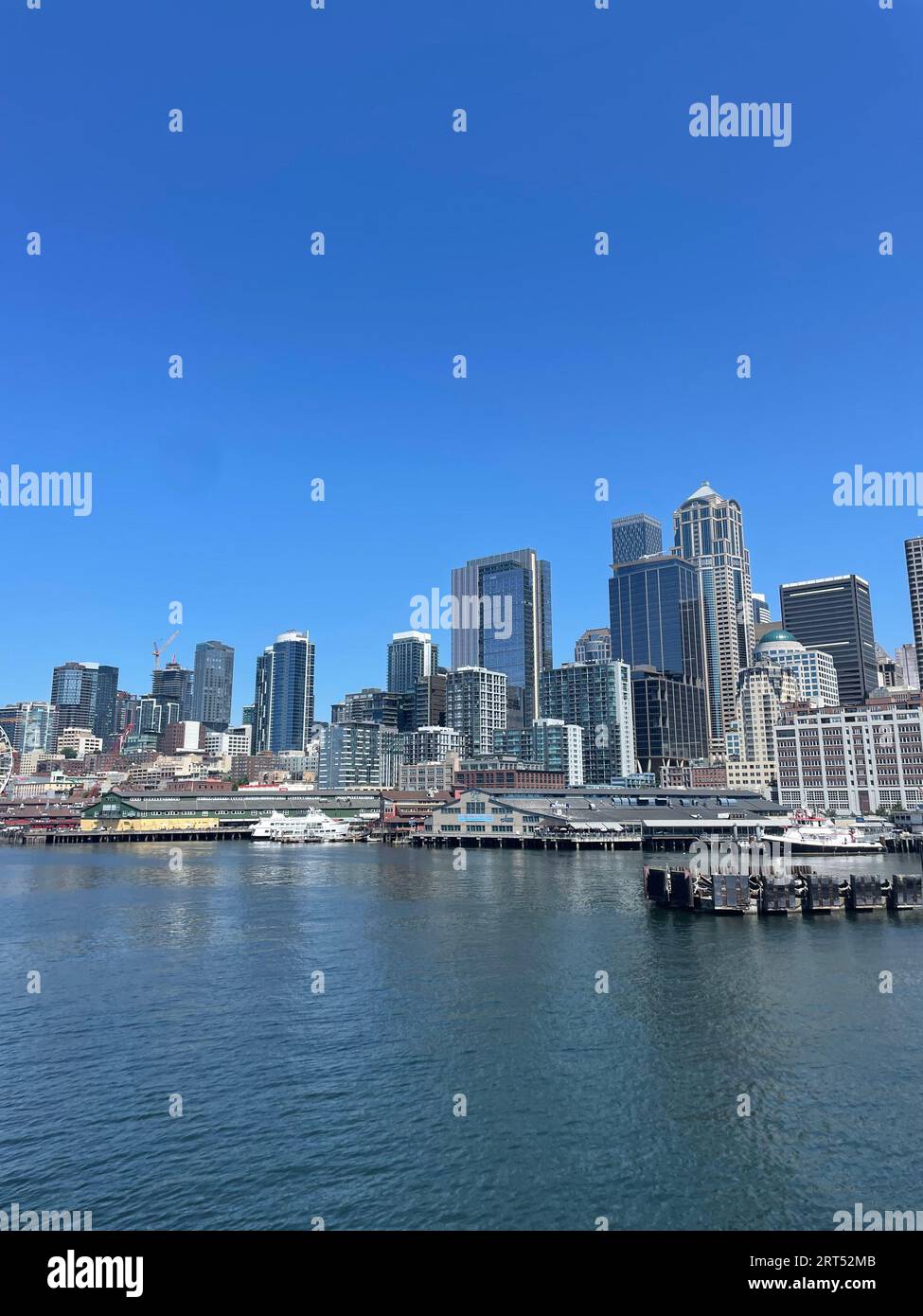 A scenic view of Seattle's iconic skyline with tall buildings and boats ...