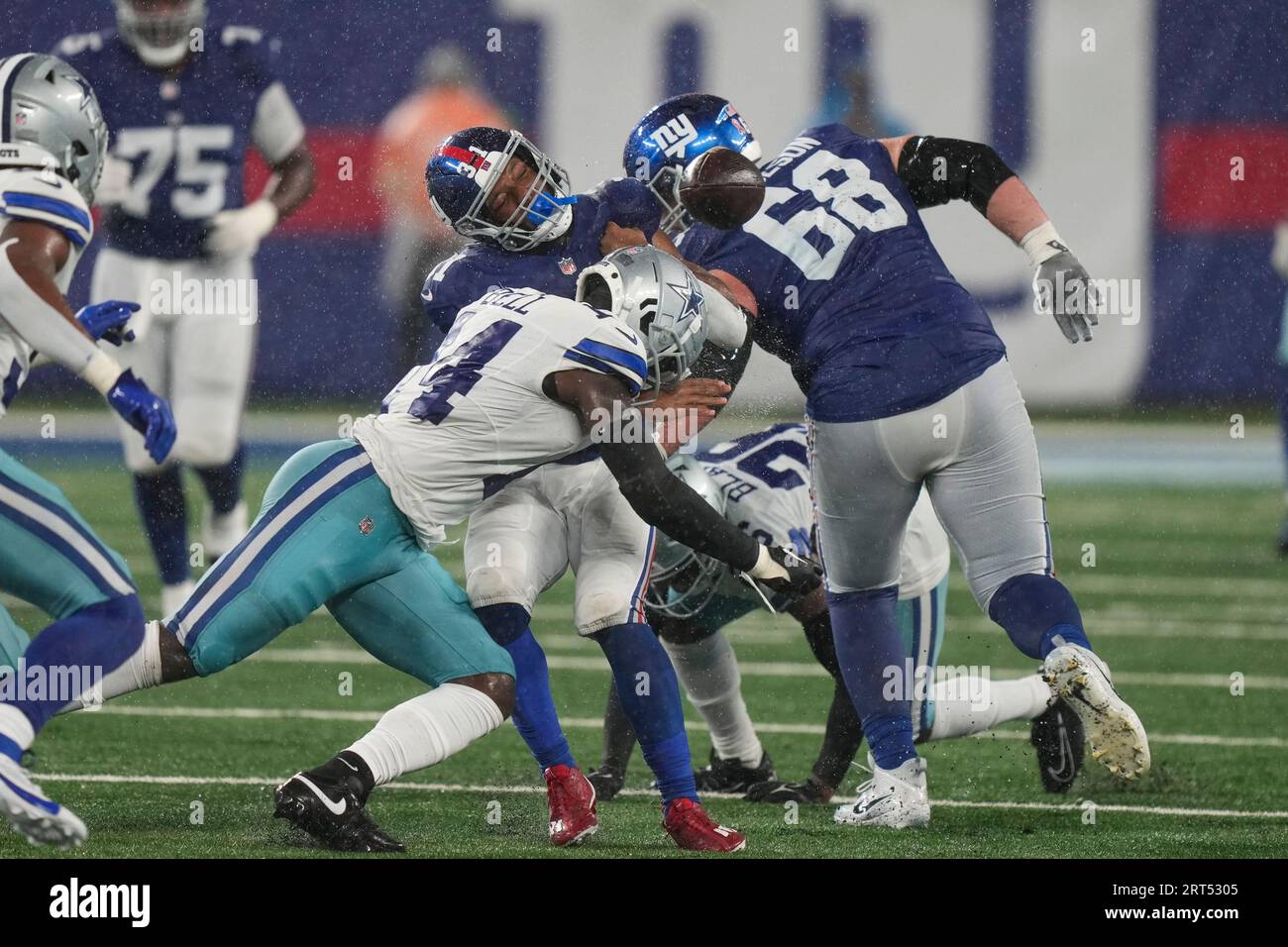 New York Giants' Matt Breida (31), center, fumbles the ball as he is ...