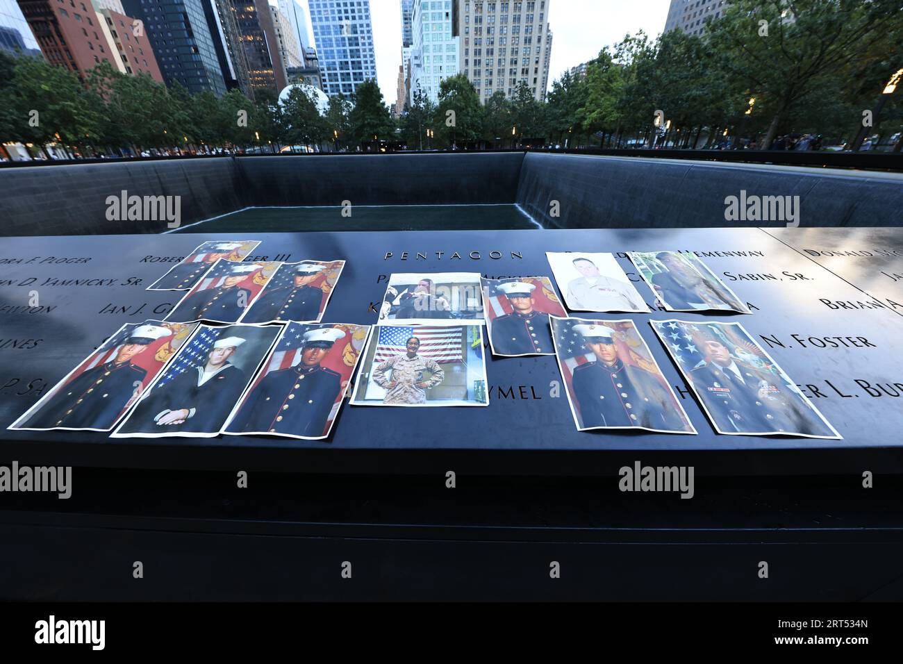 Flowers and US flags are laid on one of the South Pool panels at World ...