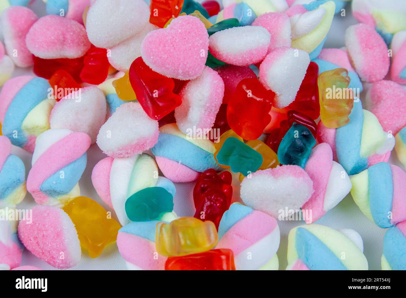 piles of various kinds of sweets and candies. Milk chocolate candy and ...