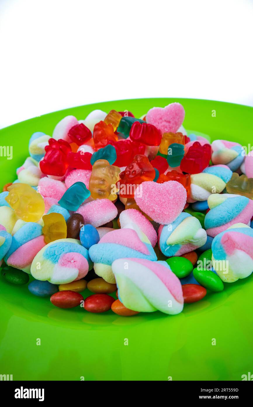 piles of various kinds of sweets and candies. Milk chocolate candy and ...