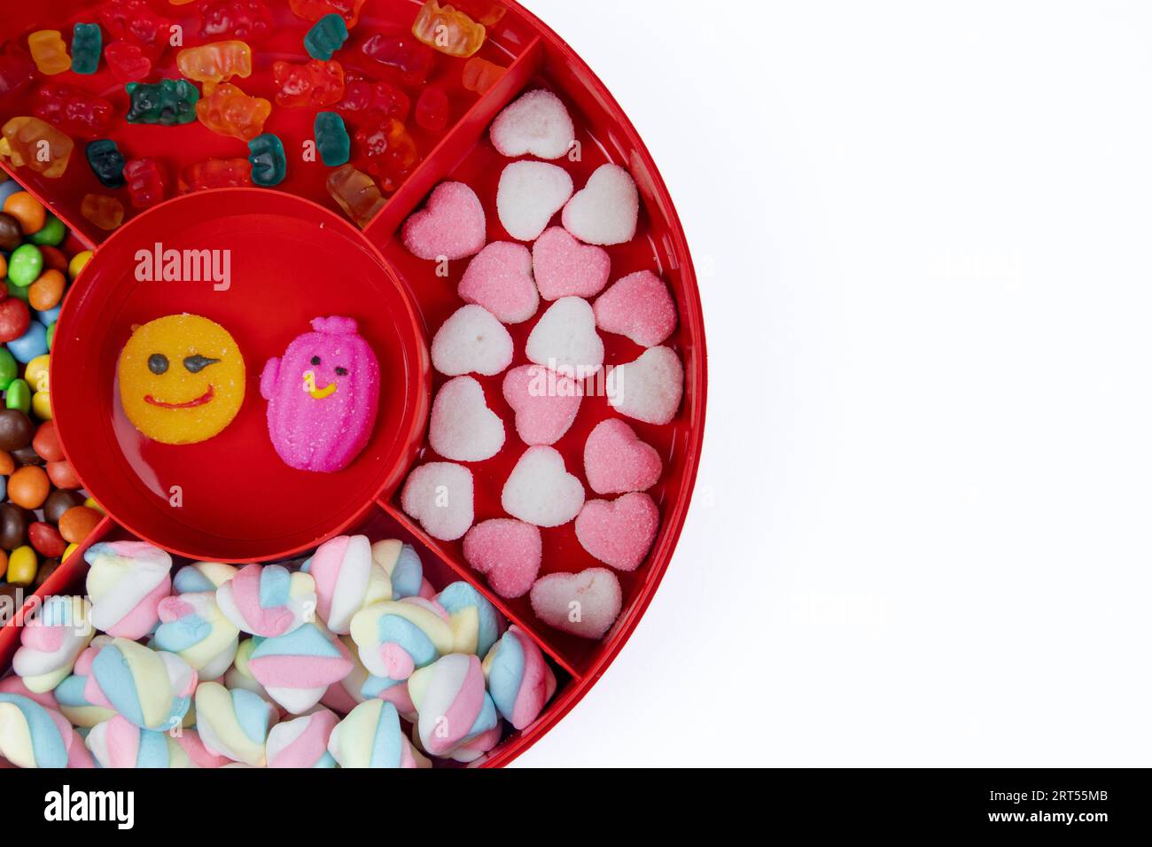 Set of different tasty candies in a red candy box isolated on white ...