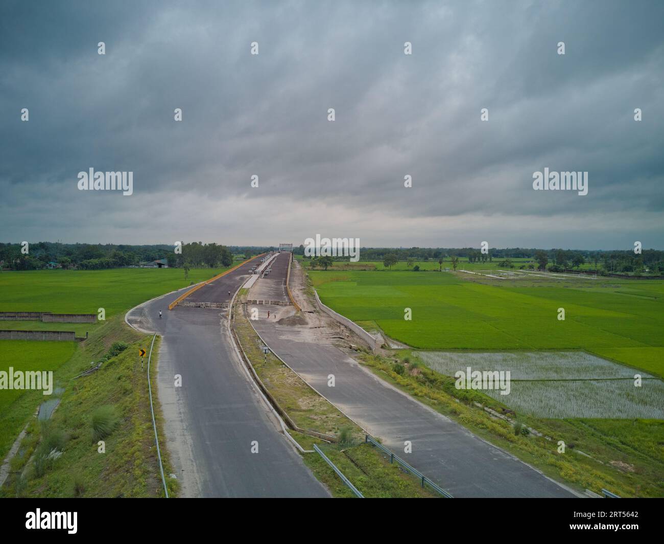 top aerial view of national highway through the agricultural field in ...
