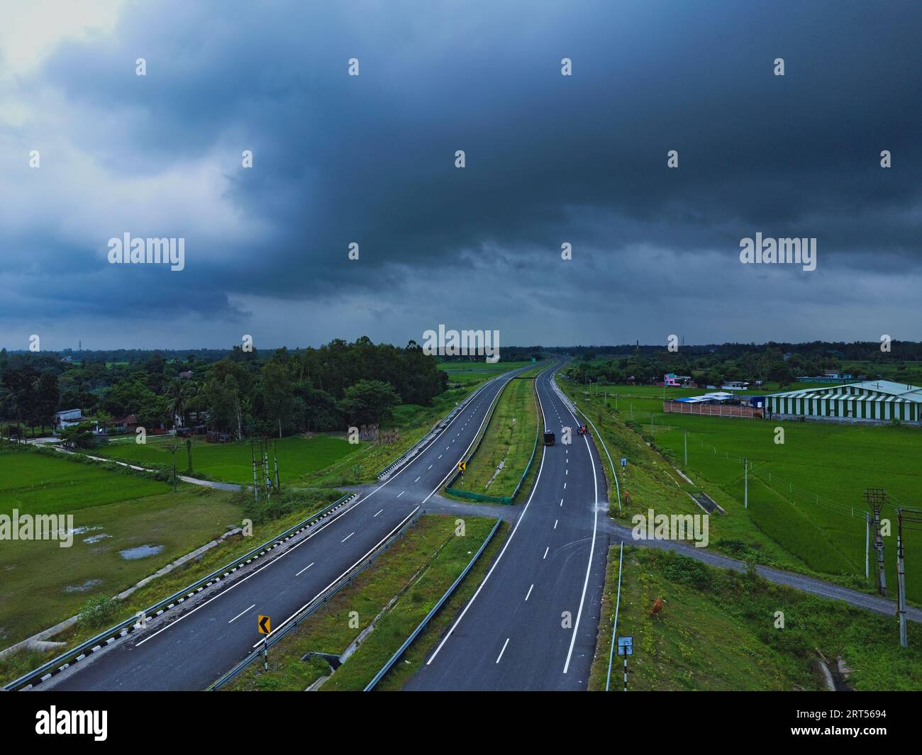 top aerial view of national highway through the agricultural field in ...