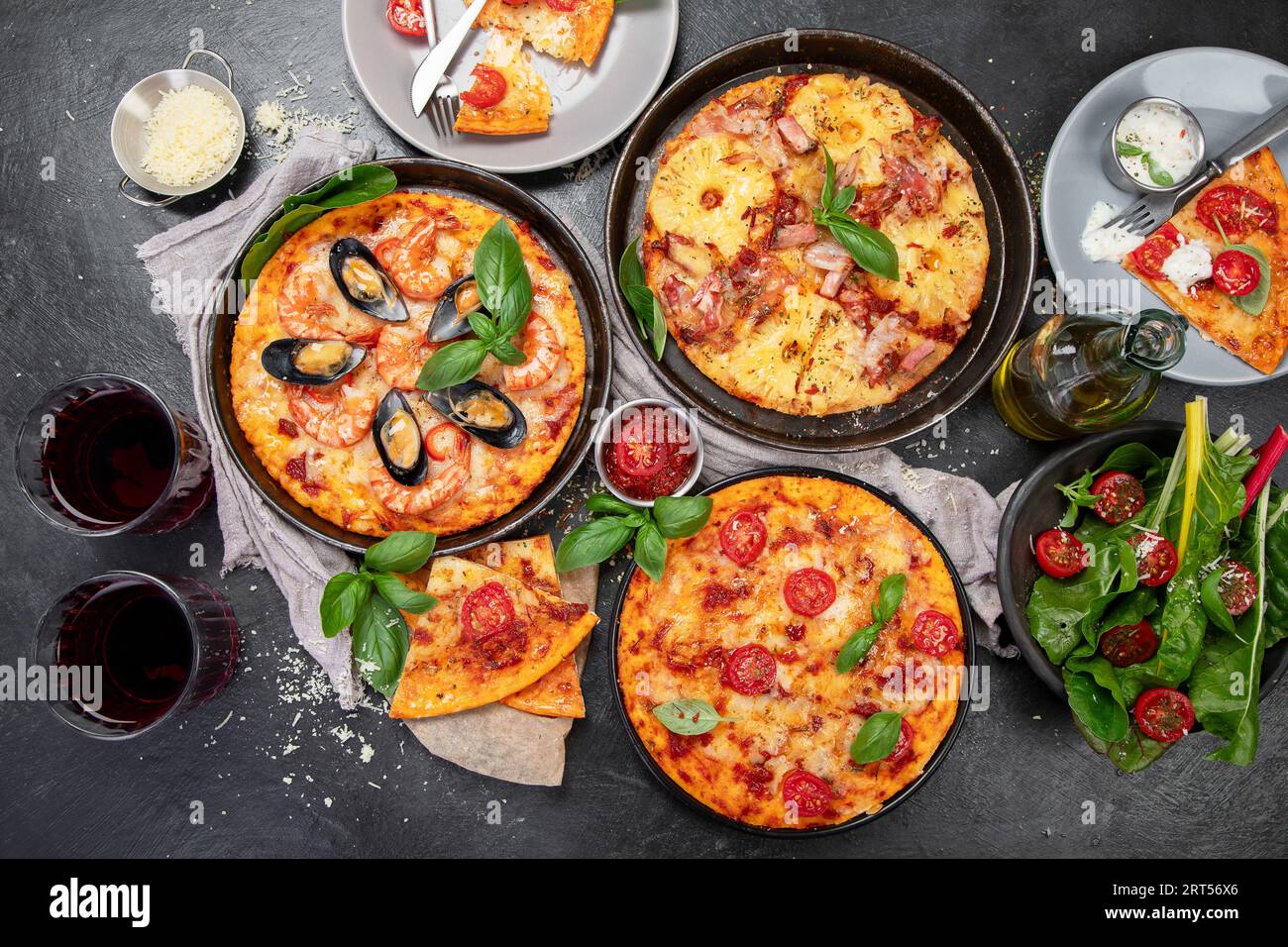 Pizza party dinner. Table with various kinds of Italian pizza, salad ...
