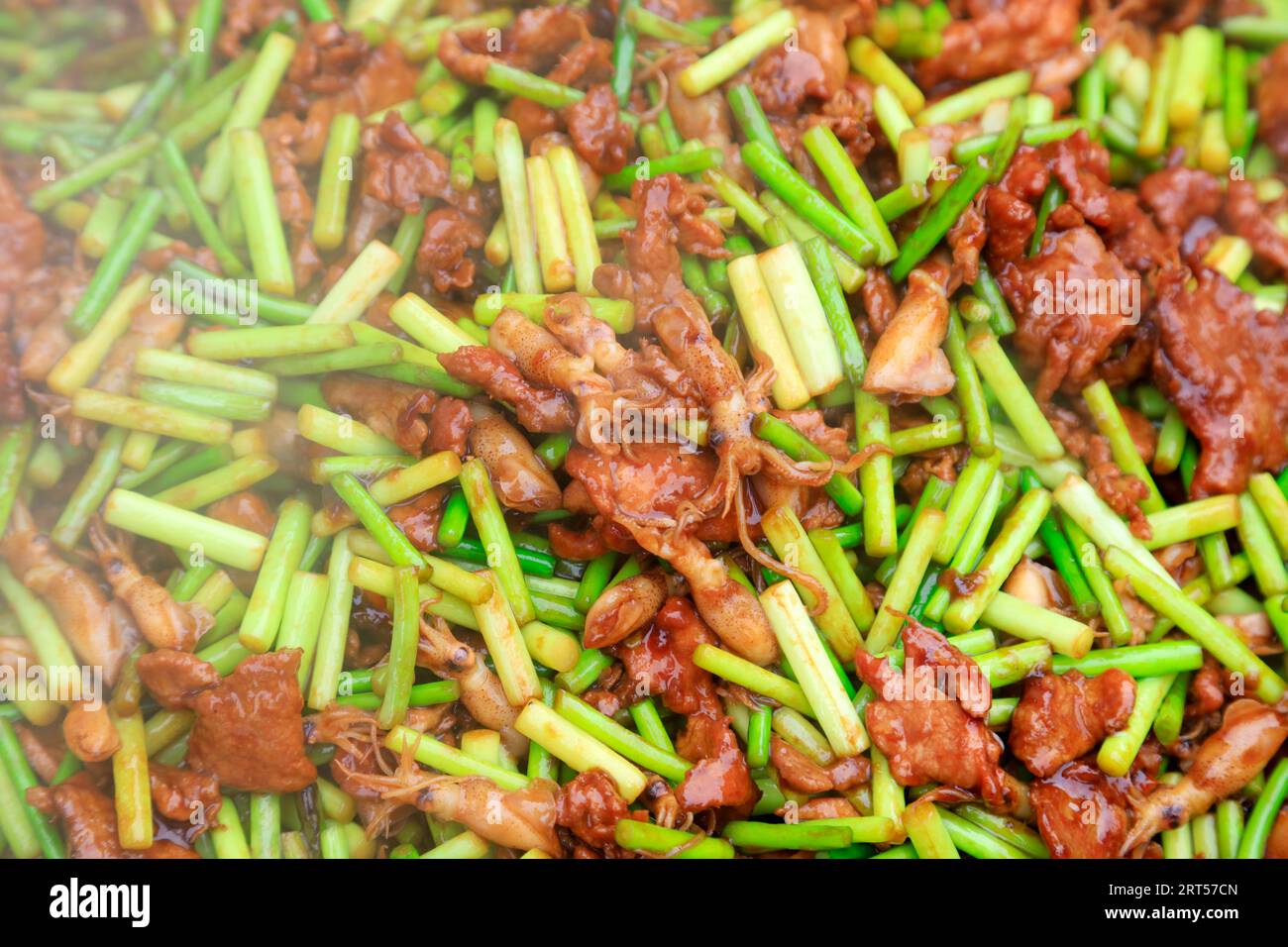 Stir fried Chinese cuttlefish with garlic sprouts Stock Photo - Alamy