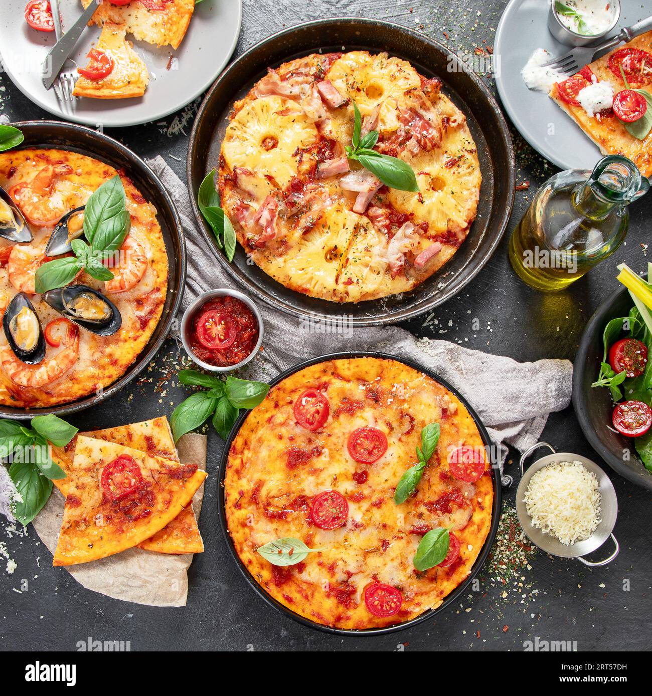 Pizza party dinner. Table with various kinds of Italian pizza, salad ...