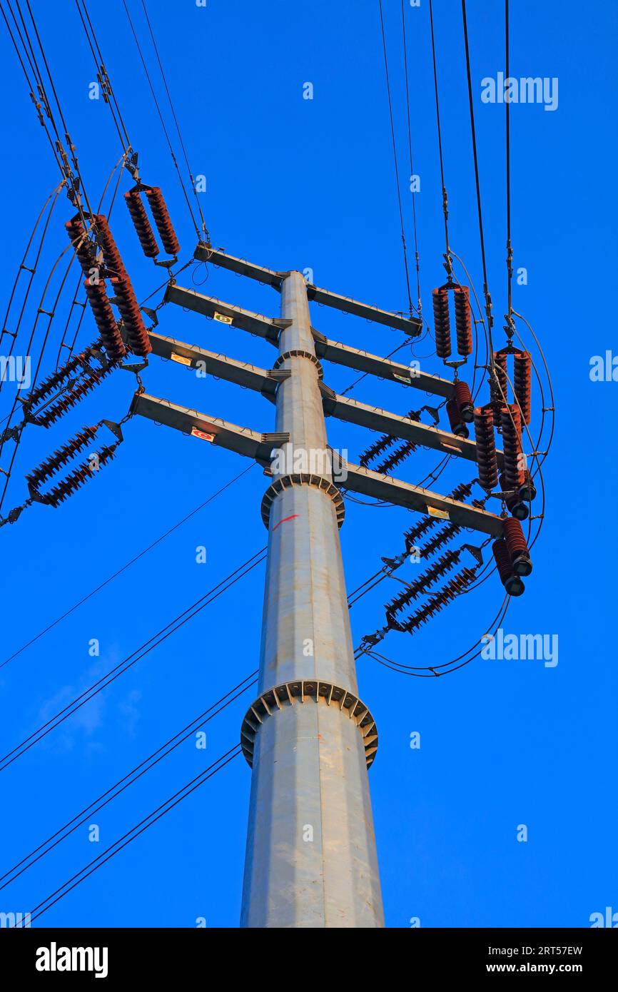 Electric steel poles in the blue sky background Stock Photo - Alamy