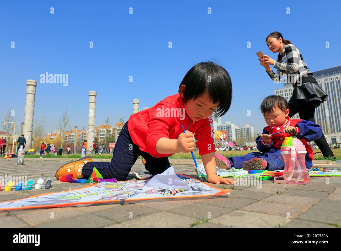Luannan County - April 15, 2017: little girl painting on a kite ...