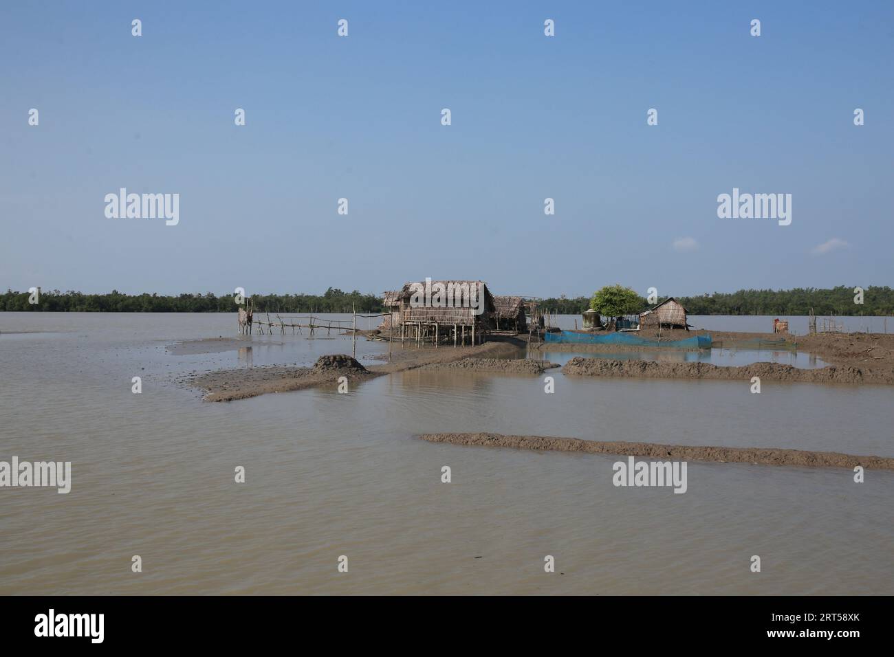 Houses are seen at the edge of the Sundarbans coastal area in Sathkhira ...