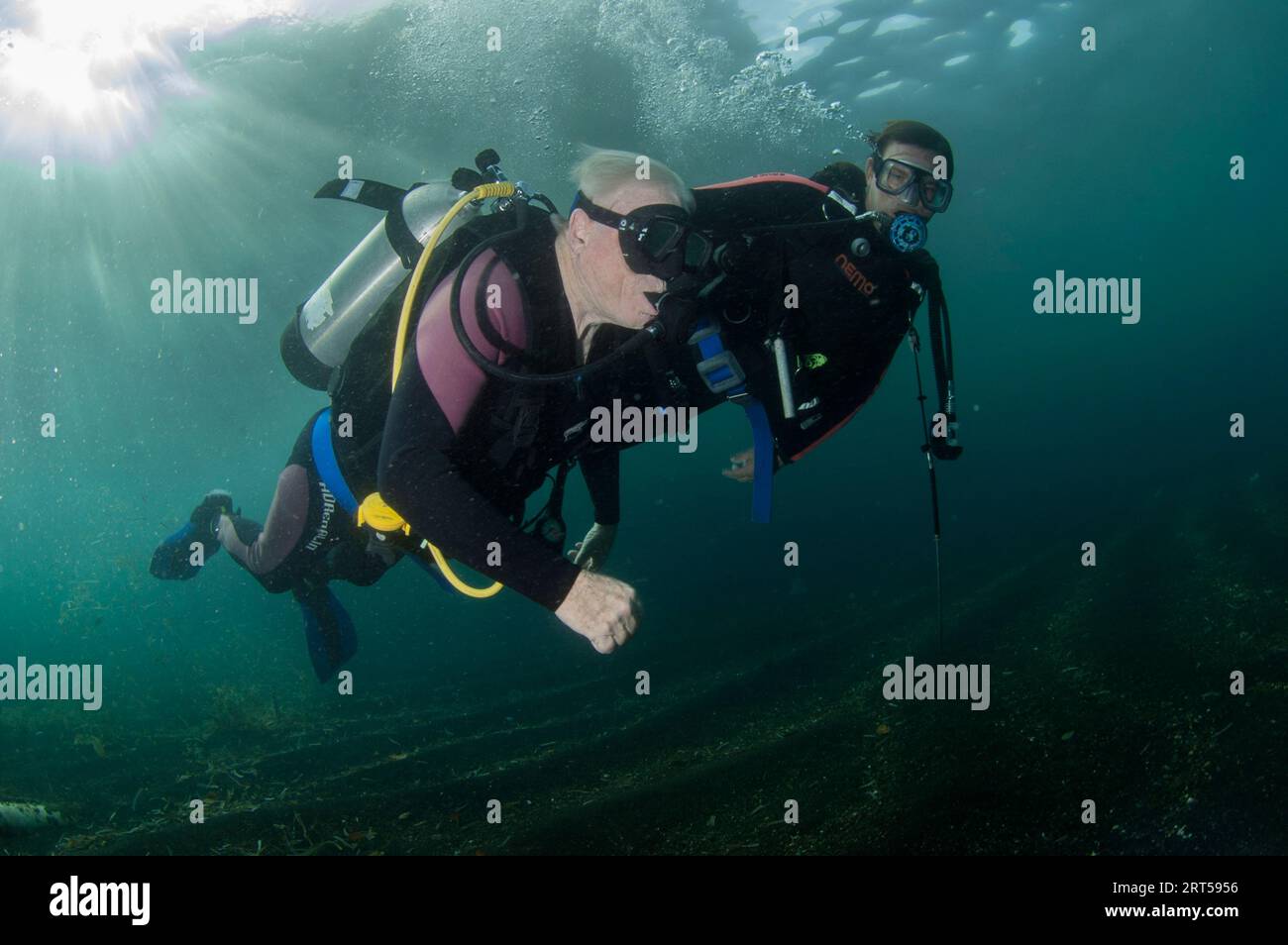 Introductory dive for instructor and 78-year old man with sun in ...