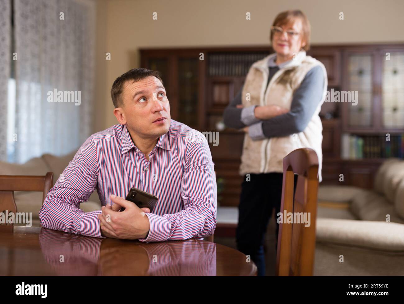 Woman scolding her adult son Stock Photo - Alamy