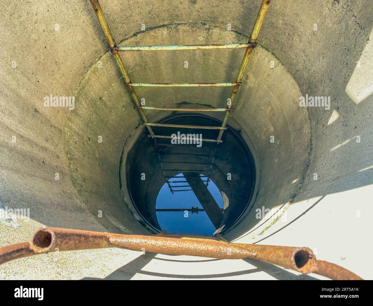 homemade well in the country. concrete rings lowered into the pit ...