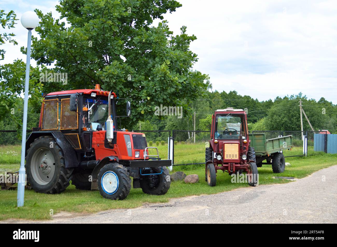 Two red professional agricultural construction tractor with large ...