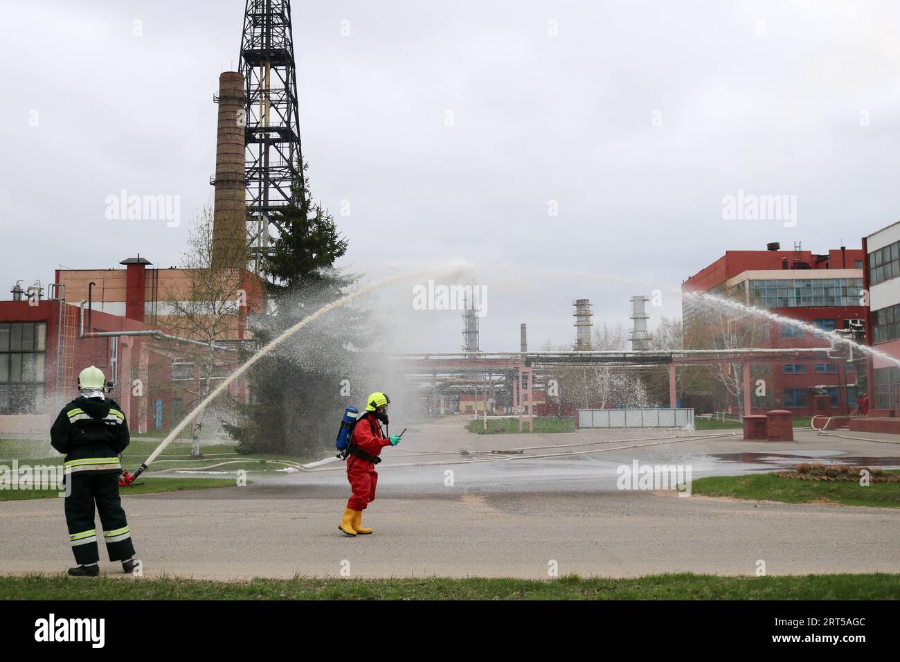 Professional firefighters in orange fire-resistant suits in white ...