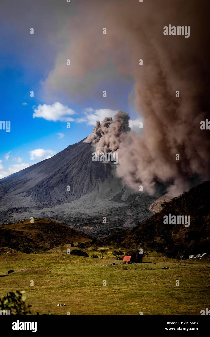 A plume of smoke billows from the active and destructive volcano at ...