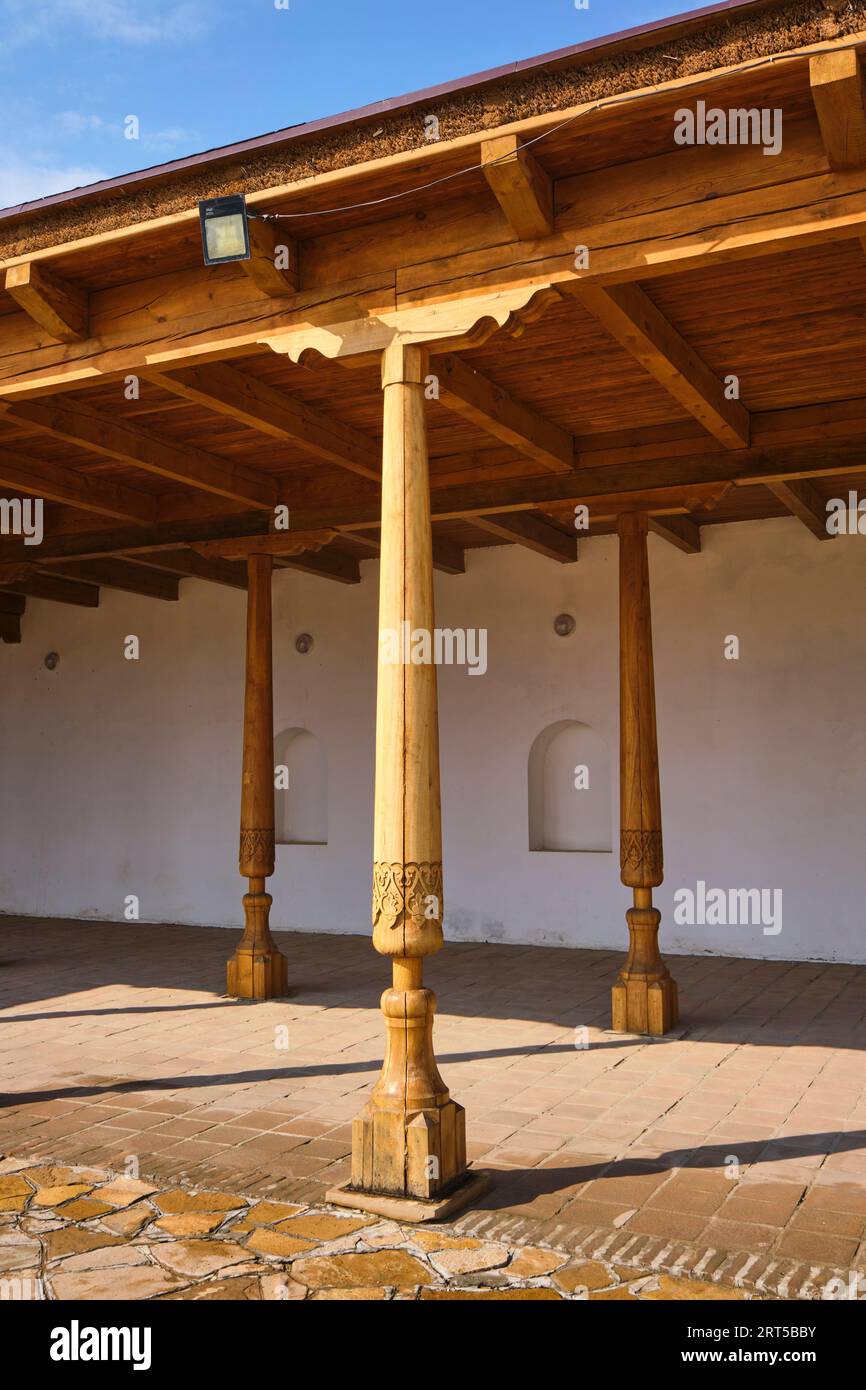 Exterior view, whitewashed walls, simple, carved columns and woodwork ...