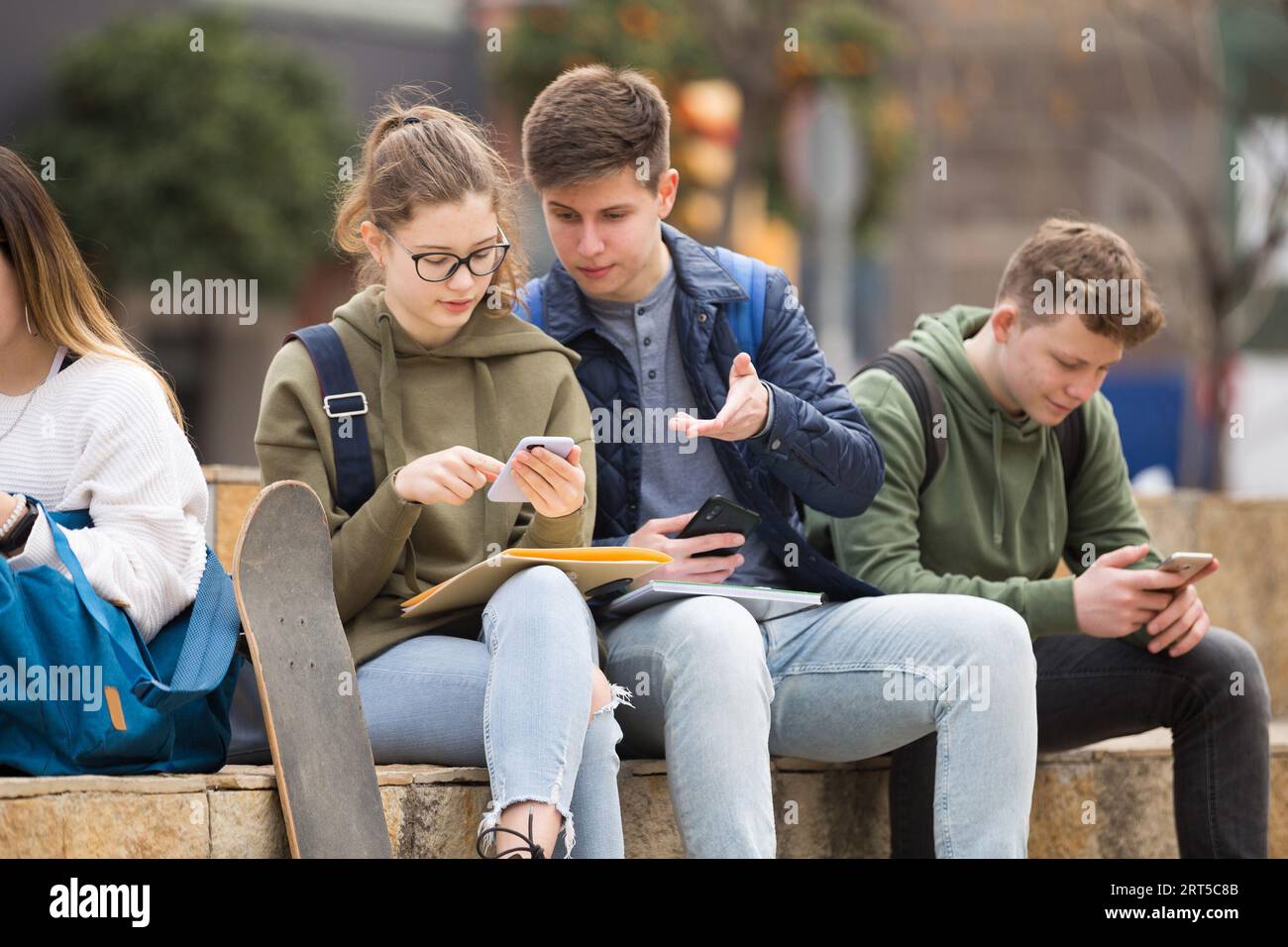 Teens using smartphones outdoors hi-res stock photography and images ...