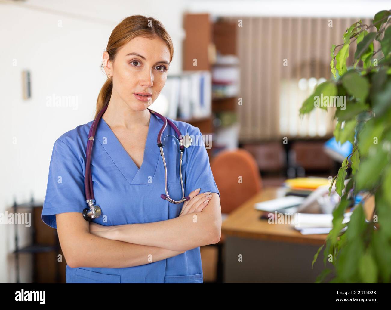Nurse standing in hall of clinic Stock Photo - Alamy