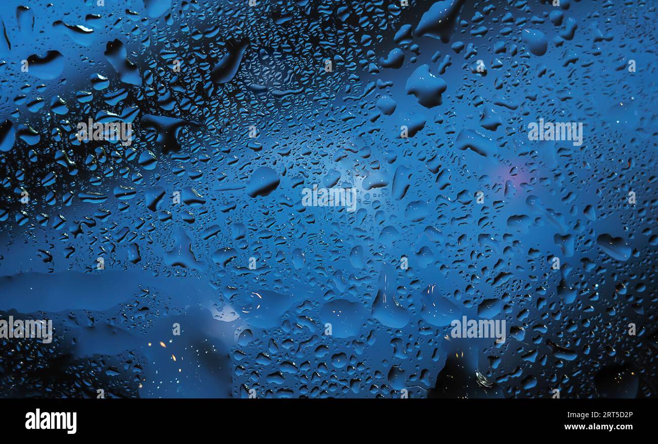 Raindrops on a clear window create a wet and rainy background Stock ...