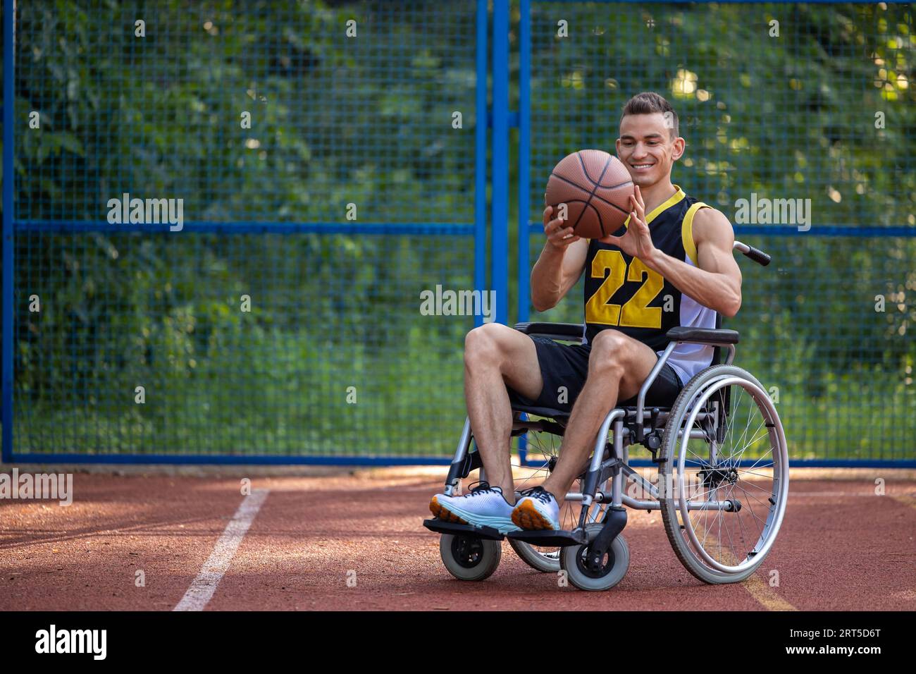Wheelchair basketball player holding, disability, outdoor basketball ...