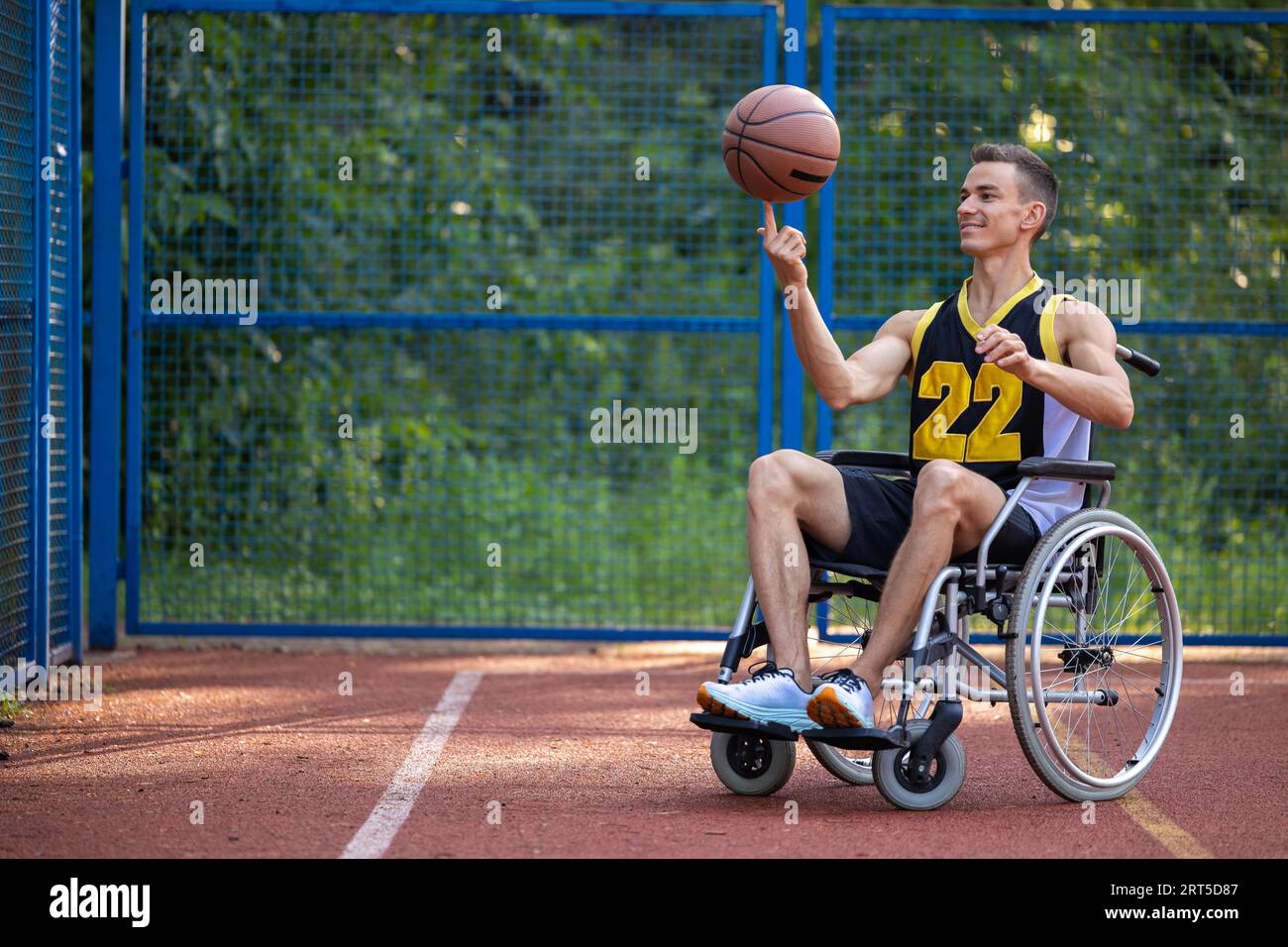 Wheelchair basketball player holding, disability, outdoor basketball ...
